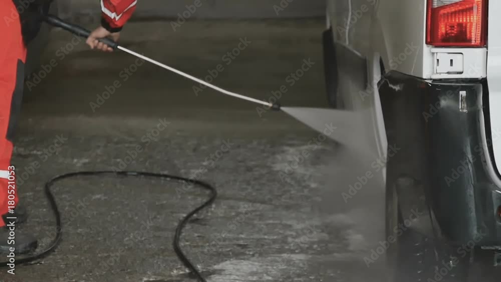Car washman cleans the car with spray of water Stock Video | Adobe Stock