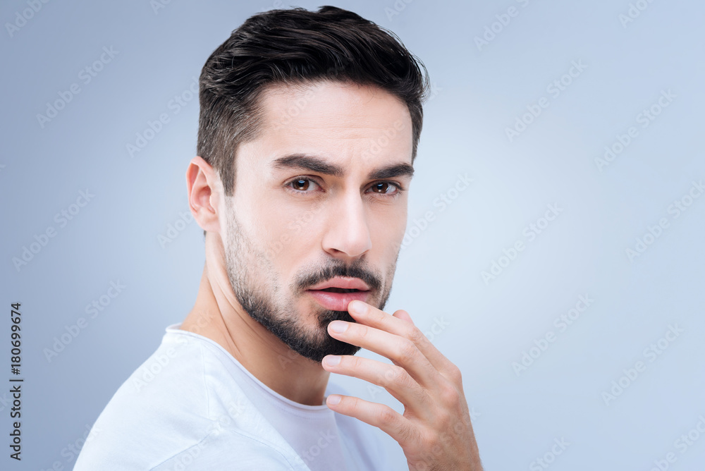 Tender touch. Romantic pleasant sensitive man looking emotional while ...