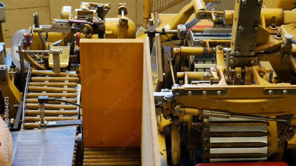 Cigar rolling machine inside a cigar factory producing homemade cigars ...