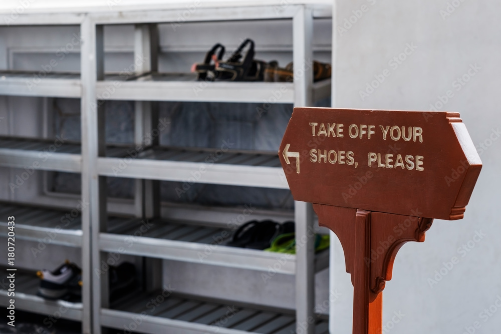take off your shoes please. sign in english language before entering ...
