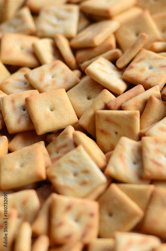 Background texture of small edible squares baked from dough and ...