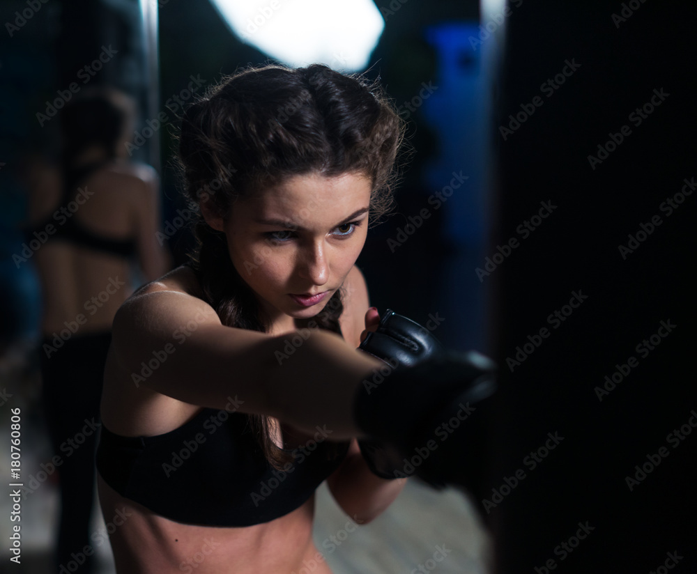 Beautiful young fighter boxer fit girl wearing boxing gloves in ...