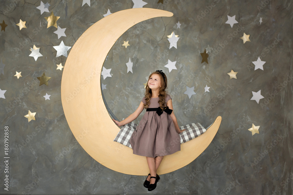 little girl in sitting on big moon. Little girl dreaming Stock Photo ...