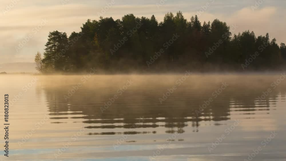 Mog creeping along the surface of the lake at sunrise timelapse ...