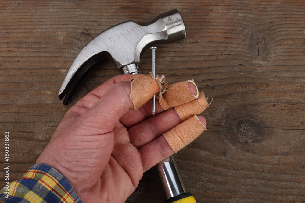 Carpenter hand fingers and hammer Stock Photo | Adobe Stock