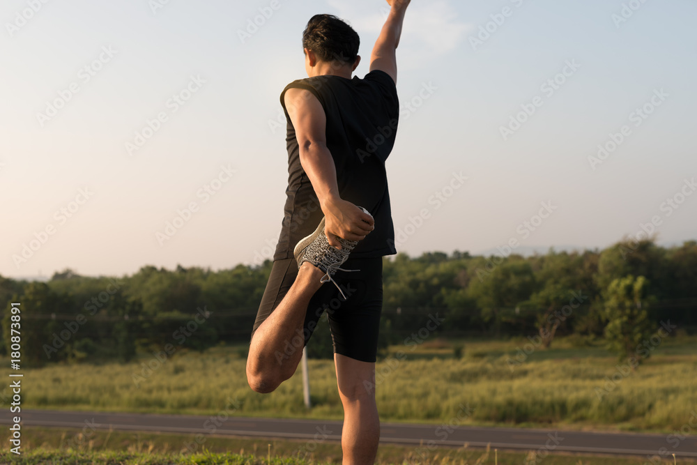 Asia young man runner doing stretching exercise, preparing for running ...