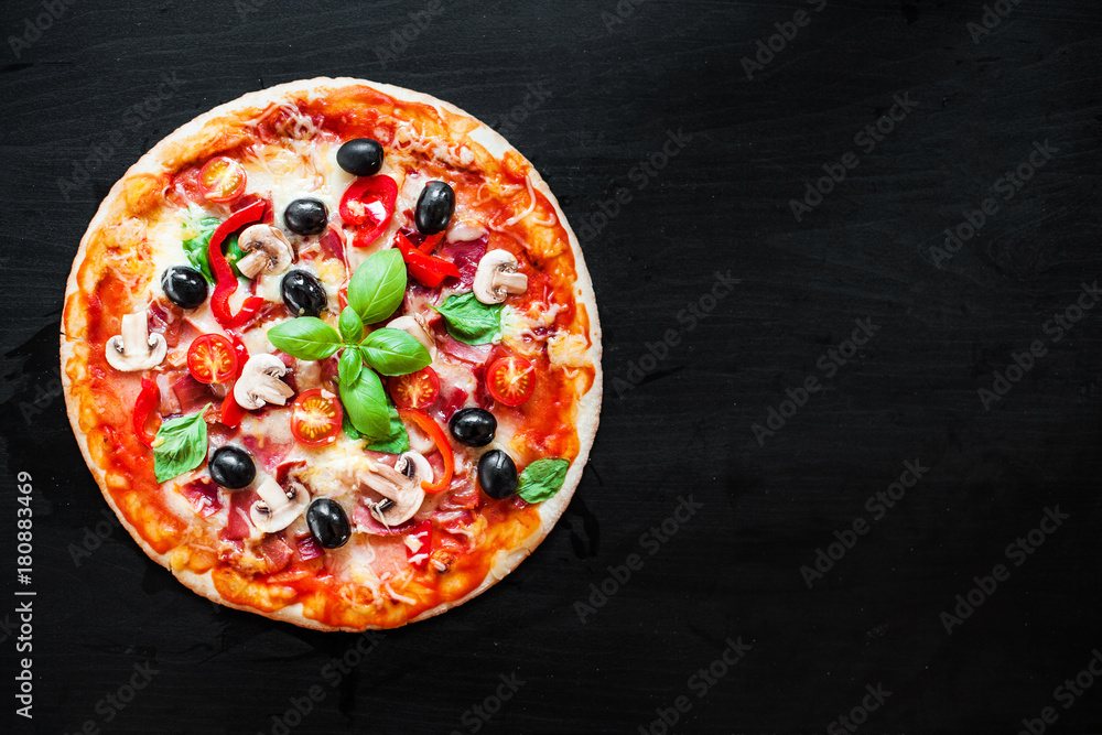 Hot pizza with Pepperoni, basil leaf on dark background with copy space ...