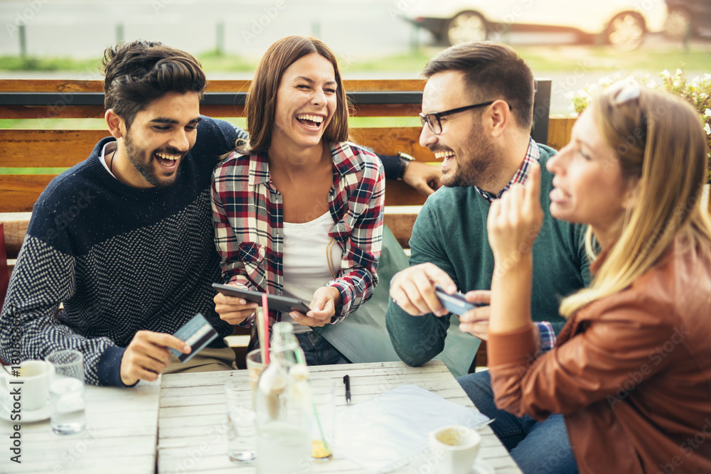 Group of four friends having fun a coffee together. Two women and two ...