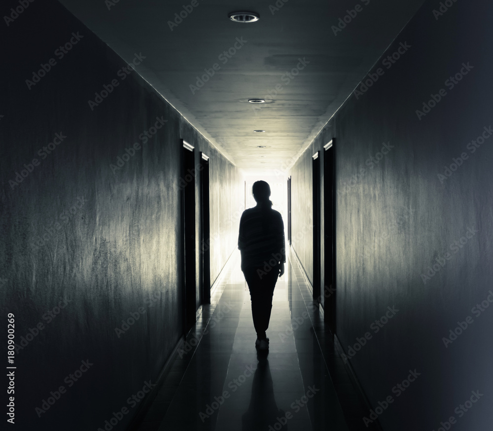 Women are walking alone in the dark.Light at the end of the tunnel ...