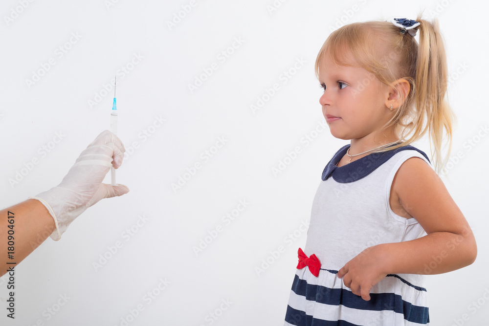 Doctor holds syringe to vaccinate sick baby with injection. Crying and ...