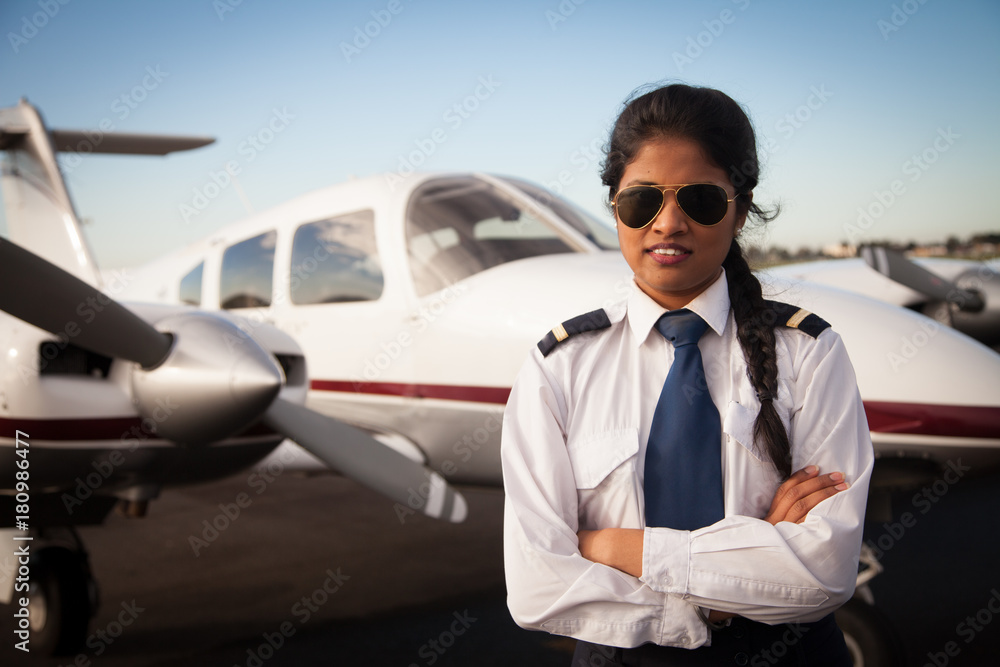 Female Pilot Standing in front of her Aircraft Stock Photo | Adobe Stock