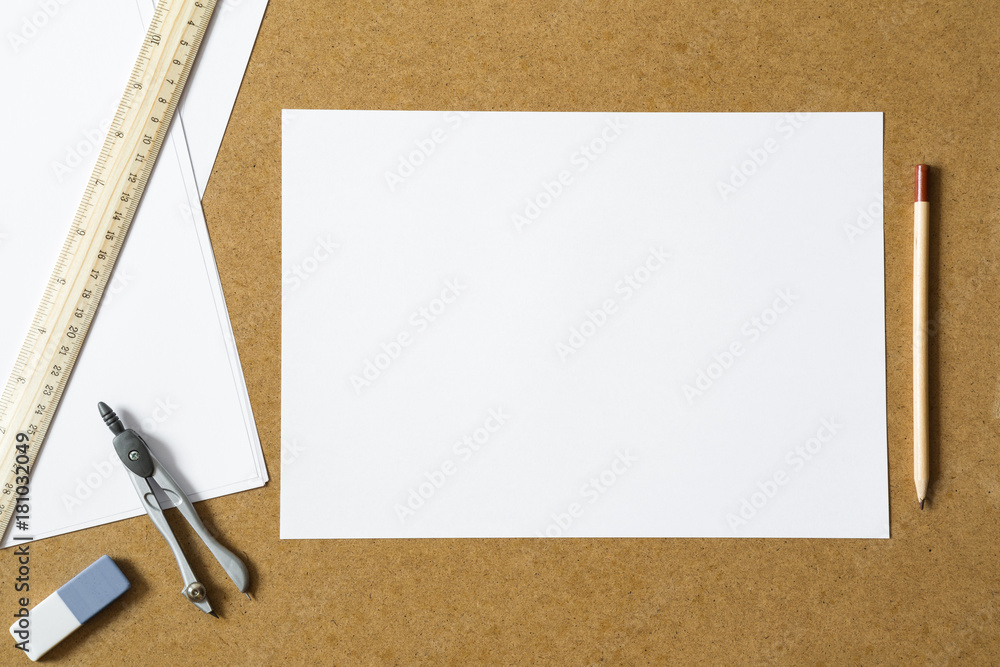 White paper sheet with pencil, ruler, drawing compass and eraser on the ...