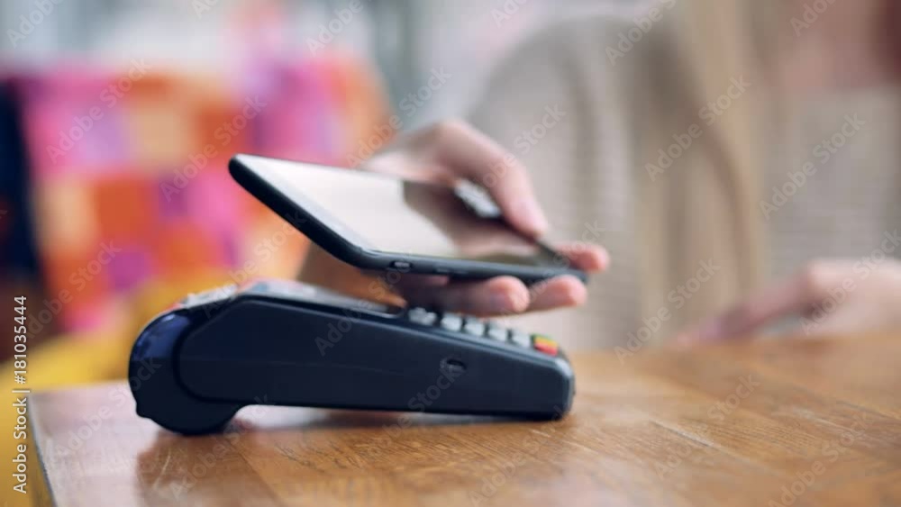 Customer uses smartphone to make a wireless payment. Stock Video ...