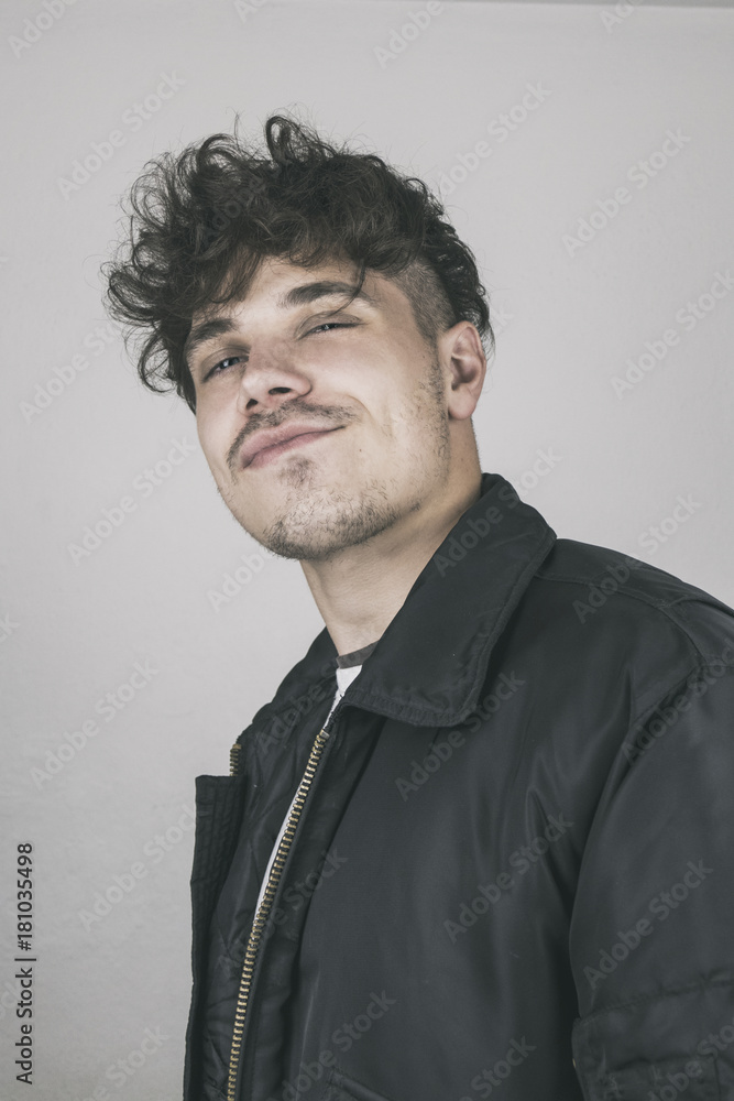 Fashion portrait photo of young and handsome man with curly hairstyle ...