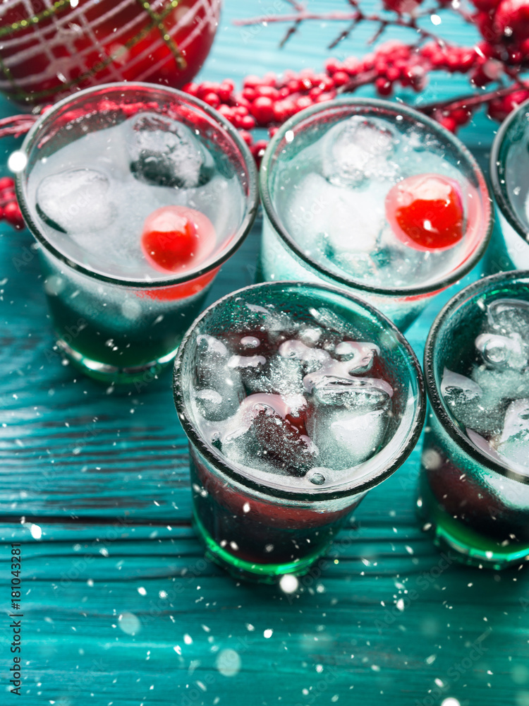 Christmas party green alcohol drinks with cherry. Festive aperitif ...
