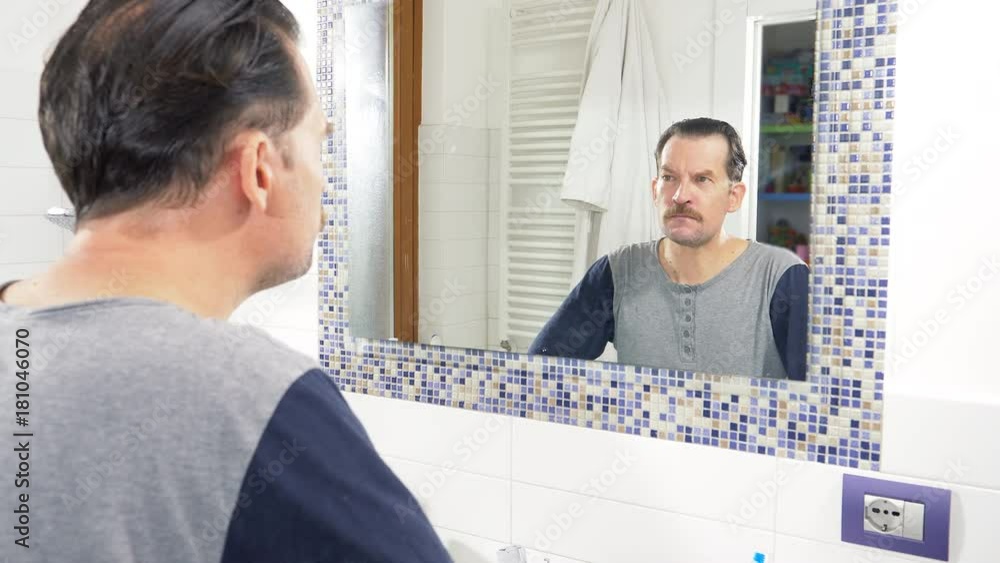 Man talking to himself angry in front of mirror in bathroom Stock Video ...