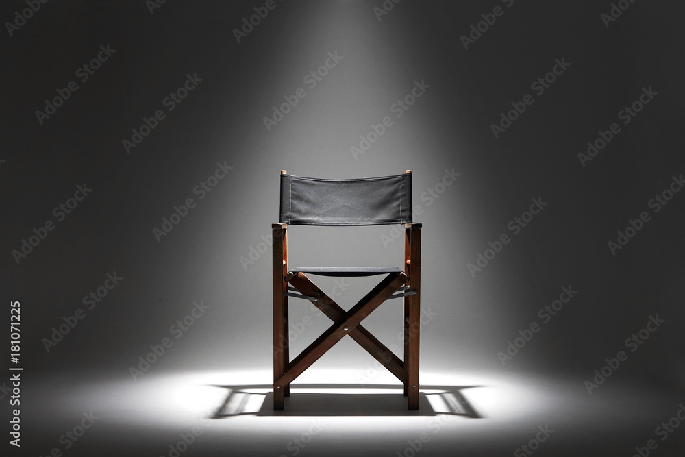 Directors chair against a plain background under a spotlight Stock ...
