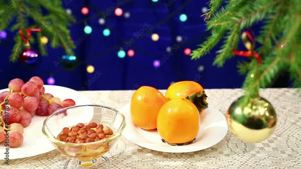 Plates with fruits and nuts with honey and are on the table with a ...
