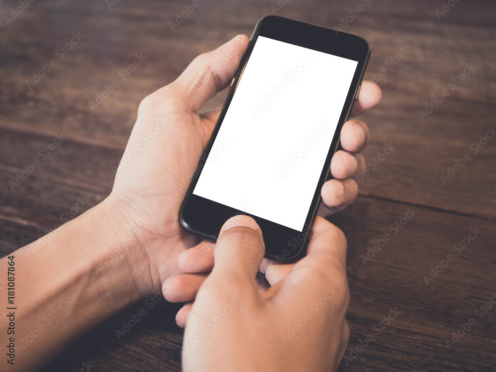 Closeup of man's hand is holding a black cell phone with blank white ...