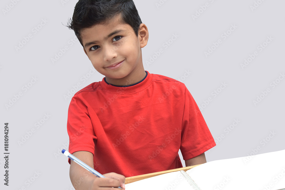 Indian kid smiling looking camera pencil in hand drawing isolated ...