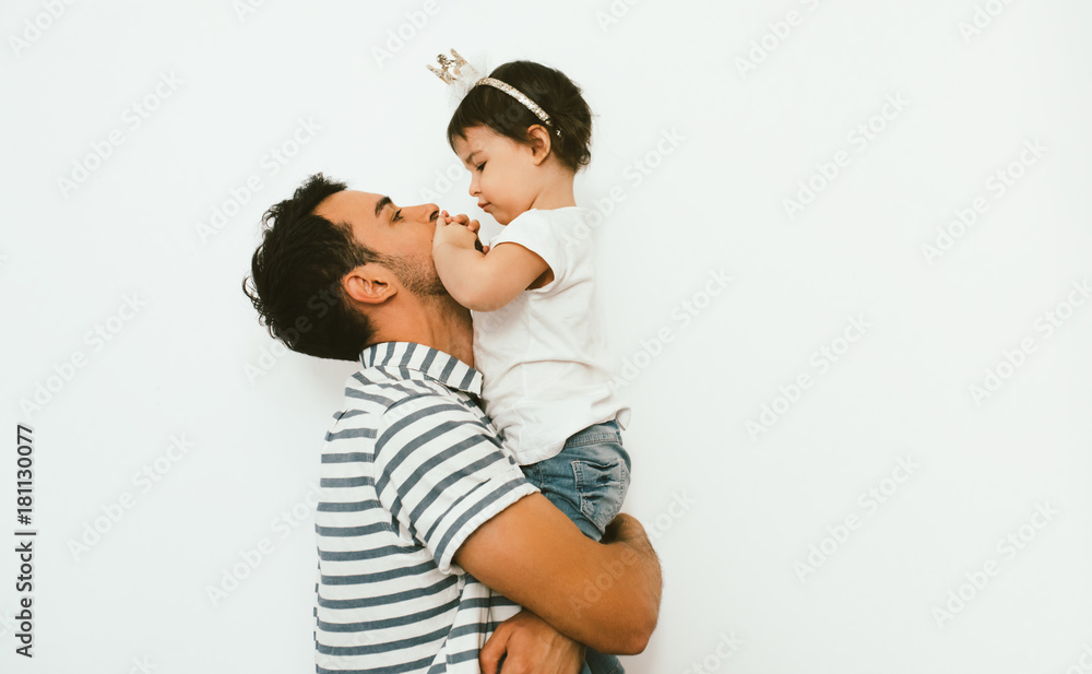 Side view of happy dad and pretty daughter play and embrace together ...