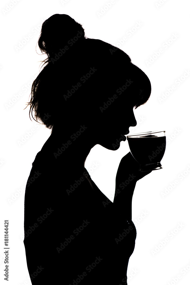 silhouette profile of a beautiful woman drinking hot black tea from a ...