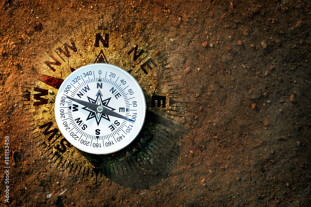 Compass on dry soil, Flat top view, Find the right way for our earth ...