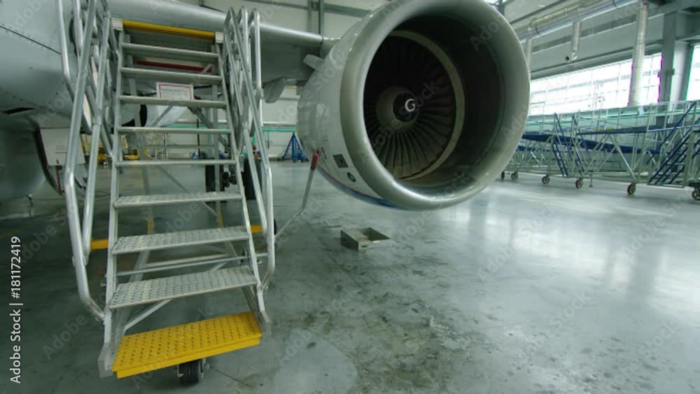 Aircraft engine in the hangar. Airplane turbine detail, plane in hangar ...