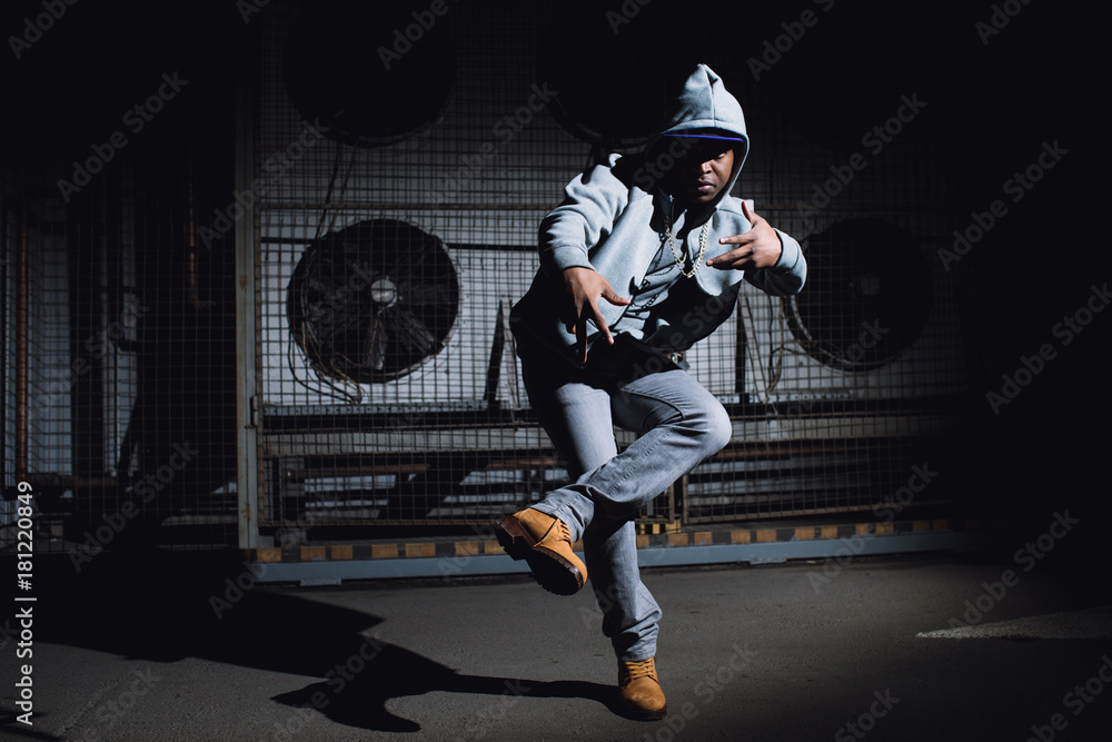 Modern rapper dancing in garage. Urban lifestyle, hip hop. Stock Photo ...