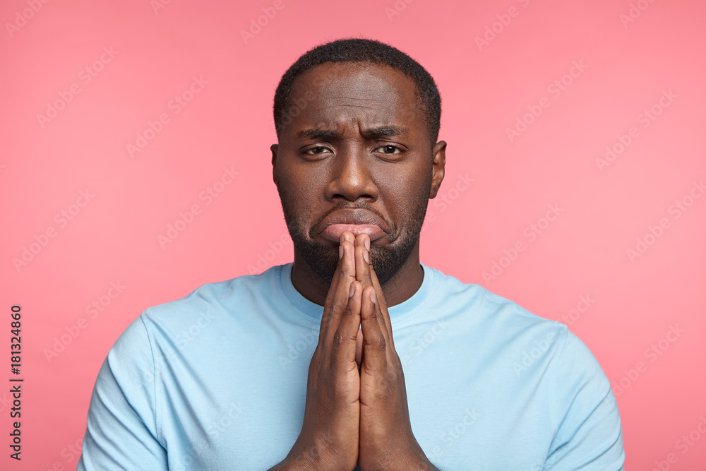 Upset praying sorrorful African male asks for forgiveness, feels guilty ...