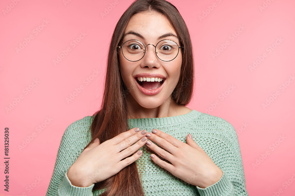 Amazed female student rejoices her success at exam, looks with bated ...
