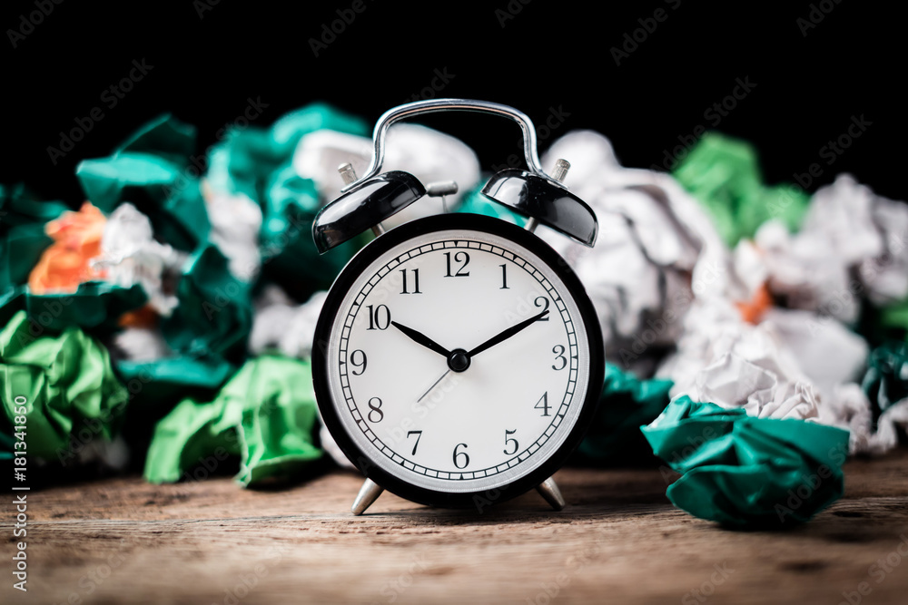 Alarm clock in a wastepaper concept for a time waste of time with cork ...