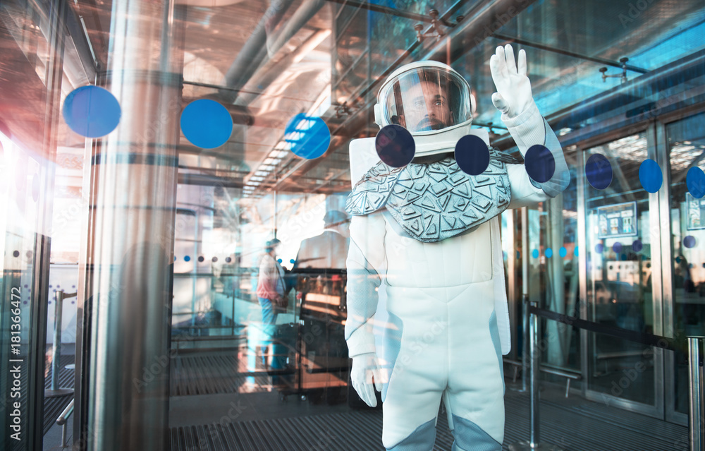 Good bye to previous life. Sad spaceman wearing uniform is standing ...