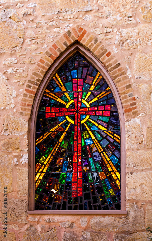 Gothic style church window with stained glass/ red cross made of ...