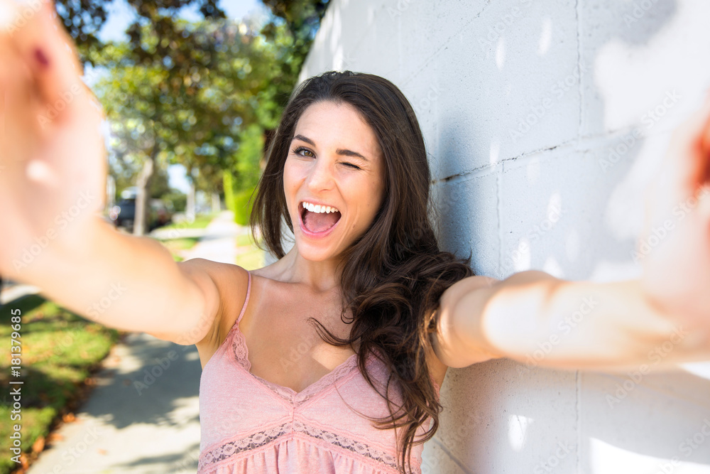 Cute adorable happy smiling young female taking a playful selfie ...