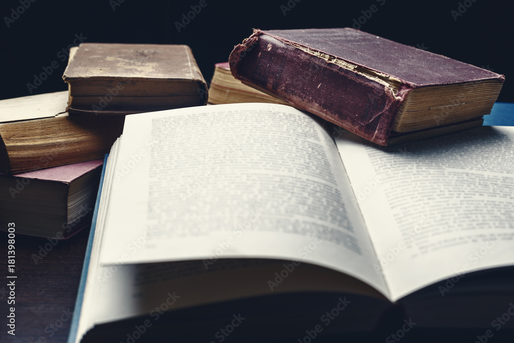 Ancient knowledge wallpaper: Opened book in front of other age-worn ...