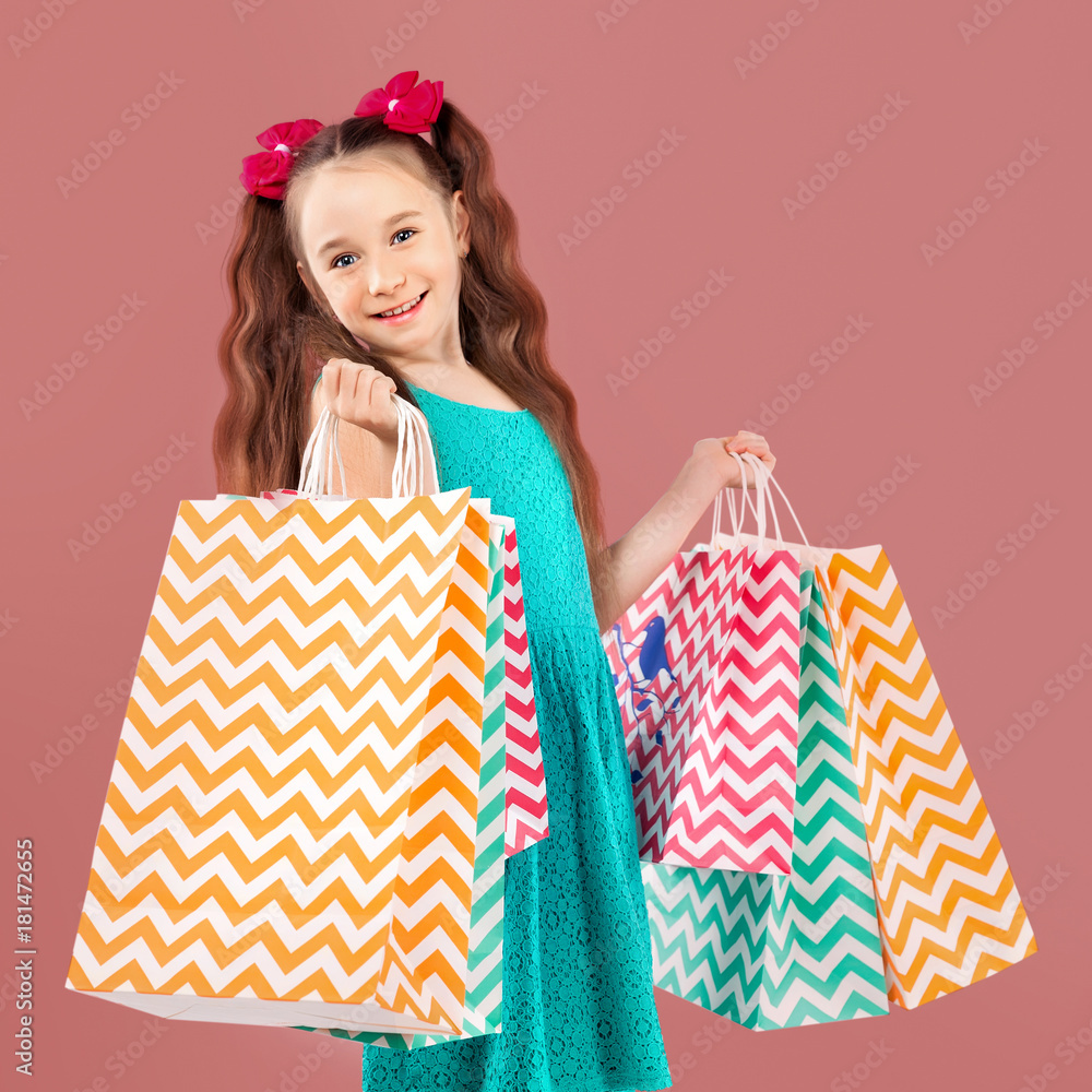 Sale. Cute little girl with many shopping bags. Portrait of a kid on ...