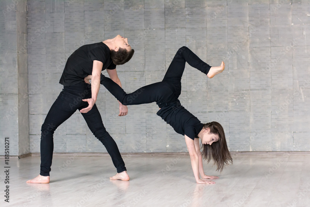 Young couple make acrobatic element. The two young modern dancers in ...