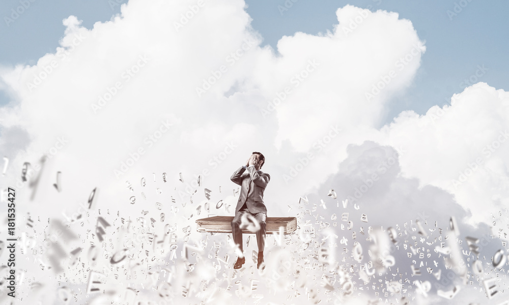 Young man floating in sky and do not want to see anything Stock Photo ...