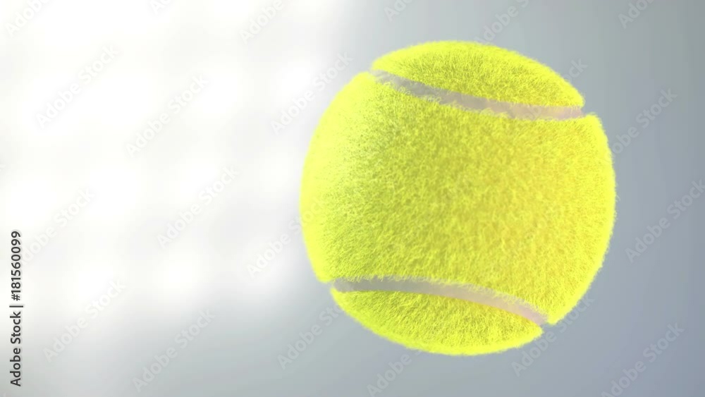 A tennis ball spinning in slow motion flying through the air on a ...