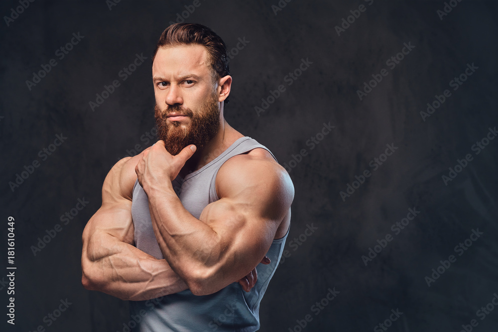 Bearded bodybuilder dressed in a tank top. Stock Photo | Adobe Stock