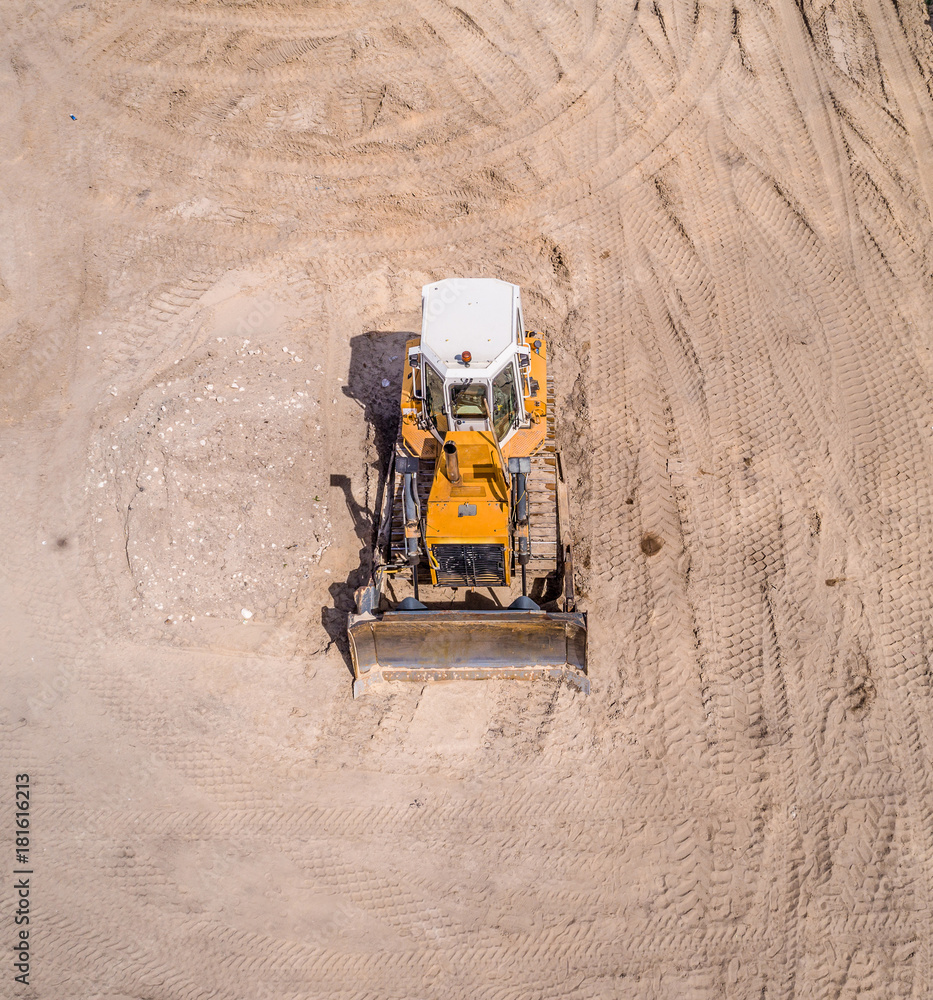 bulldozer on the construction site top view. Shooting from the drone ...
