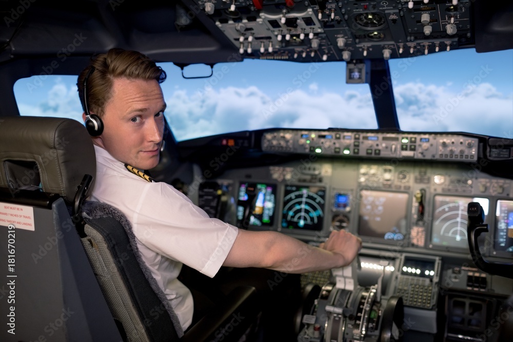 Portrait of handsome young male pilot flying airplane Stock Photo | Adobe Stock