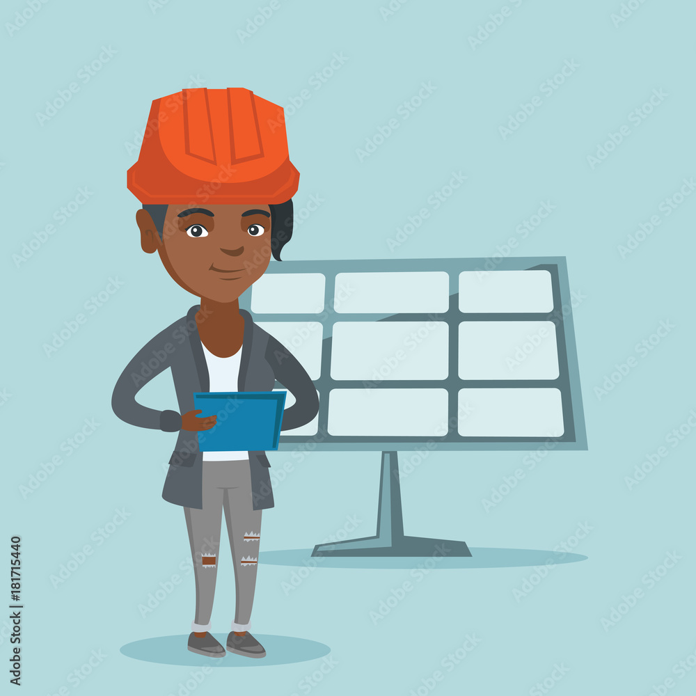 Young african-american engineer in hard hat working on a digital tablet ...