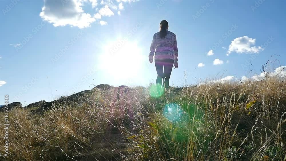 Low angle of woman on top of mountain at Sunset Hiker Girl celebrating ...