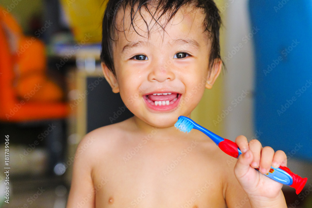 kid boy brushing teeth and smiling Stock Photo | Adobe Stock