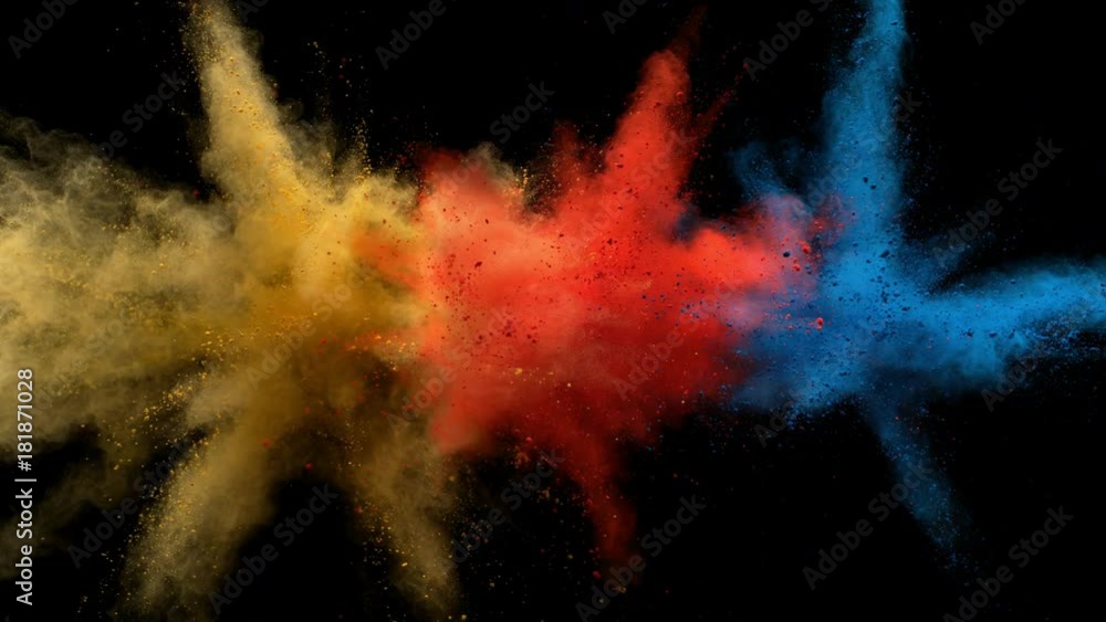 Colorful powder/particles fly after being exploded against black ...