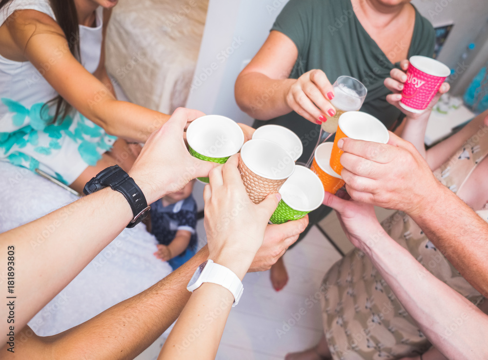 Group of friends cheers with cups. People hands cheering and toasting ...