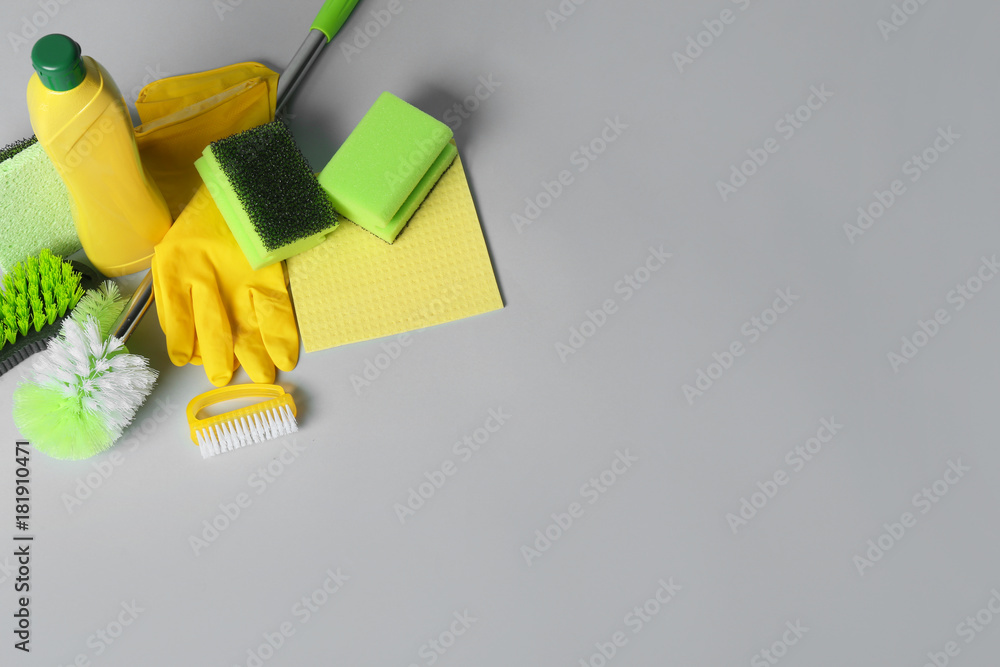 Cleaning supplies on grey background Stock-Foto | Adobe Stock