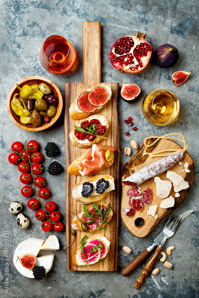 Appetizers table with italian antipasti snacks and wine in glasses ...